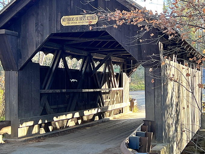 Sunlight filters through the wooden slats, creating patterns that dance across the floor like spectral footprints from another time.