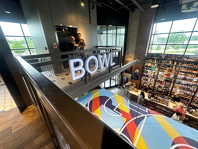Balcony view with "BOWL" sign: From this perch, witness the beautiful madness of a gas station that somehow houses a bowling alley – peak Michigan innovation!