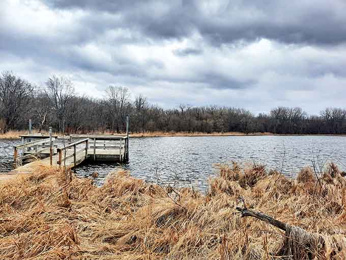 A peaceful fishing pier extends into the calm waters, offering moments of reflection after exploring the hidden canyon nearby.