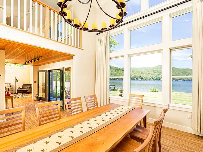 Denslow Cottage: Soaring ceilings and panoramic windows frame lake views so perfect they seem almost painted rather than real.