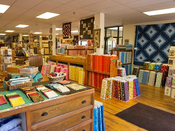 A quilter's dream layout &ndash; wide aisles, wooden floors that whisper with history, and enough fabric to keep your sewing machine humming for decades.
