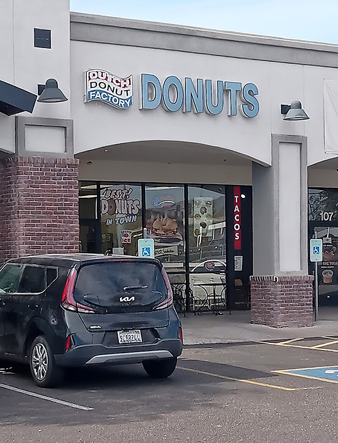 Dutch Donut Factory's clean storefront and distinctive blue signage stands out in Mesa's morning landscape.