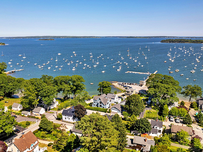 Falmouth spreads beneath a canopy of green, where wealthy homes hide among trees with glimpses of Casco Bay beyond.