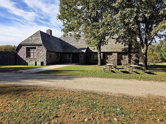 Flandrau State Park's stone lodge stands as a testament to 1930s craftsmanship, welcoming visitors to its wooded grounds.