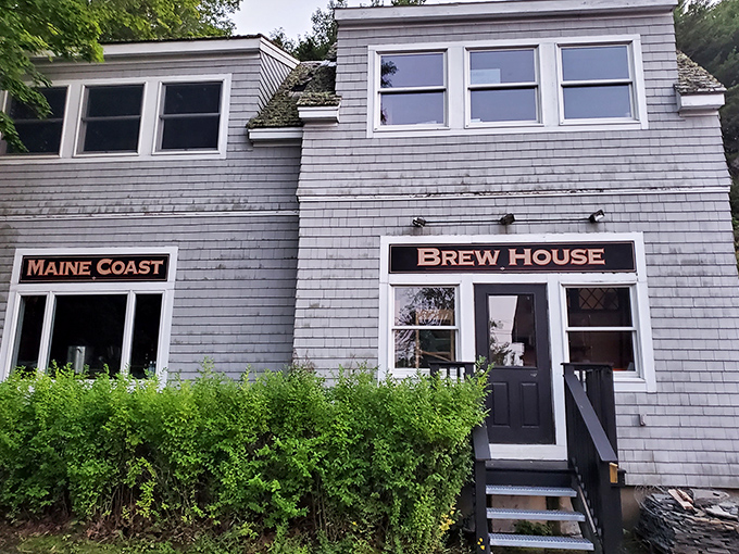 Maine Coast Brew House sign sits beside the entrance to Jack Russell's Steakhouse, promising craft beers to complement your steak dinner.