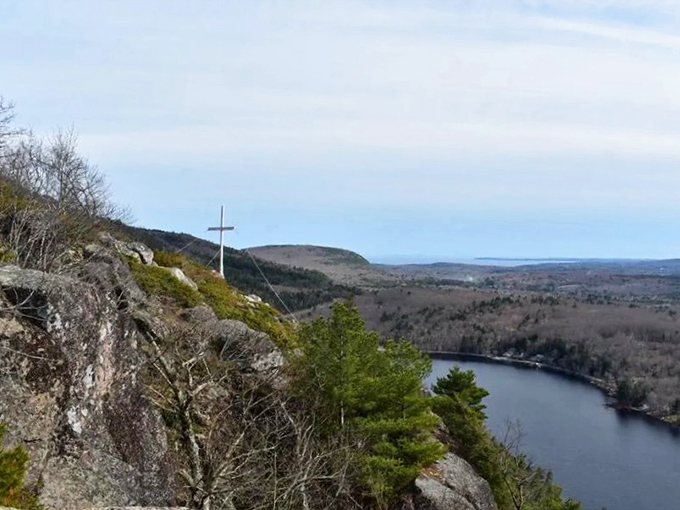 A simple white cross marks Maiden's Cliff, standing sentinel above the vast panorama of Megunticook Lake and the surrounding countryside. 