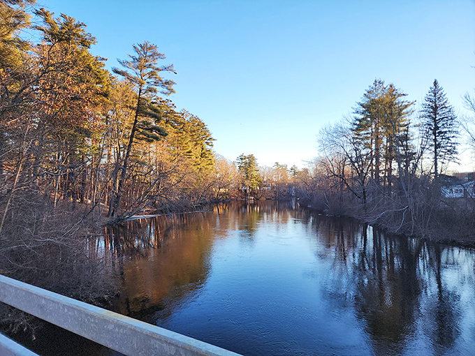 Messalonskee Lake's expansive waters catch the morning light, revealing the exceptional clarity that makes it a central Maine swimming favorite.