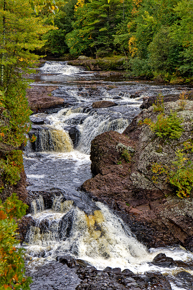 Potato River Falls thunders through a rocky gorge, showcasing the raw power of Wisconsin's northwoods waterways.