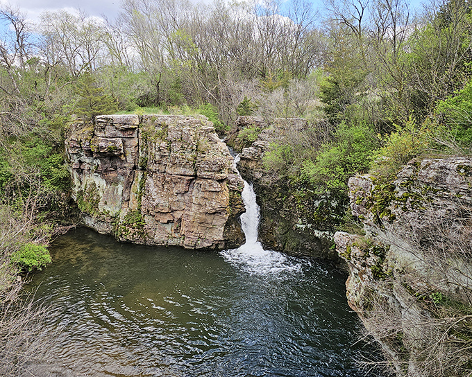Red Rock Falls flows over colorful stone that looks like the earth mixed its own custom paint colors just for this spot.