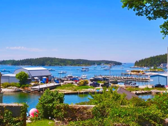 Stonington's working waterfront showcases weathered buildings on stilts, testament to generations of fishing families.