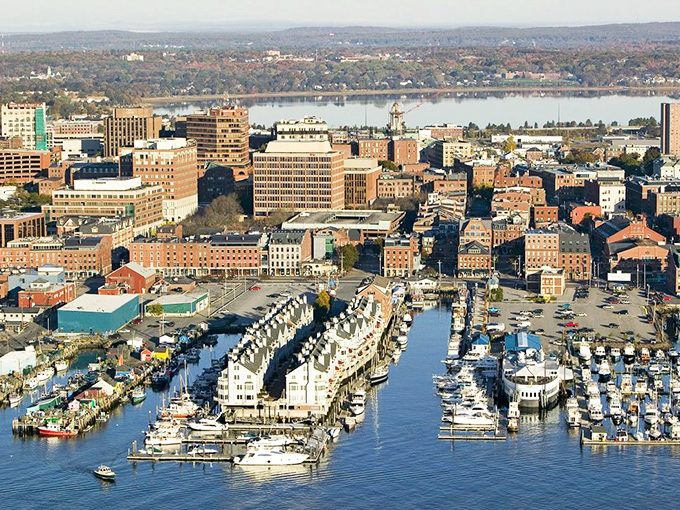 A bird's eye view of Falmouth reveals a patchwork of buildings and blue water, showcasing Maine's beauty.