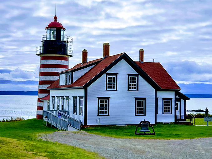 The iconic West Quoddy Head Lighthouse near Lubec features distinctive red and white stripes against a backdrop of dramatic coastal scenery.