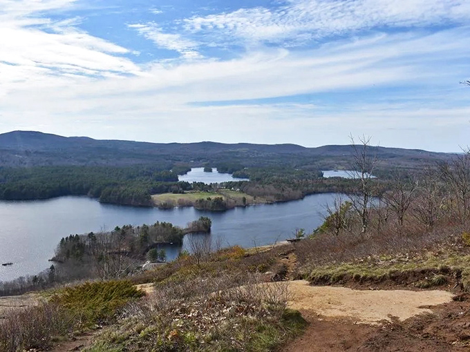 Maiden's Cliff offers sweeping views across lakes and forests to distant mountains, showcasing Maine's diverse landscape in one breathtaking vista. 