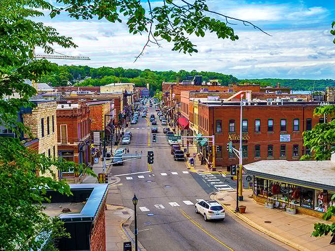 An aerial view of Stillwater shows its picturesque setting along the St. Croix River, with historic buildings nestled against the hillside.