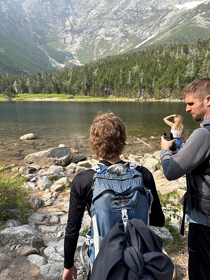 Lakeside contemplation: where thoughts become as clear as the water reflecting those magnificent mountains.
