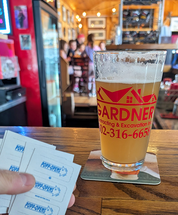 A golden local brew catches the light in a branded glass &ndash; pop-opens on the table hint at Vermont's casual hospitality and beer appreciation.