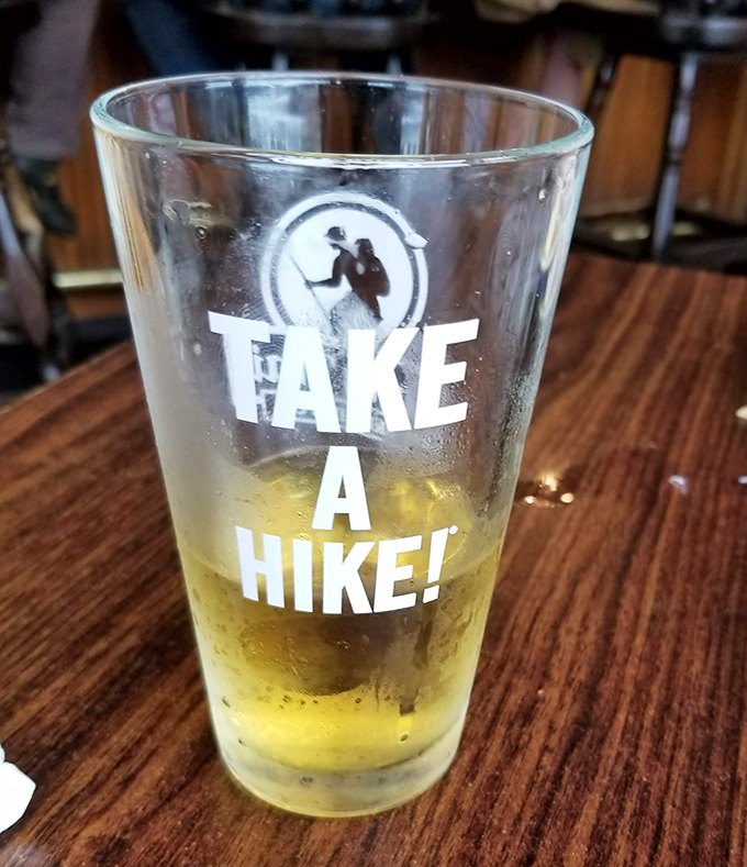 "Take a Hike!" says the glass, but the golden brew inside begs you to linger just a little longer.