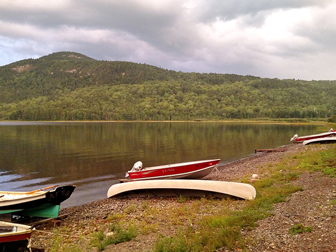 Lakeside parking only: Colorful boats rest on the rocky shore, ready for another day of exploration.