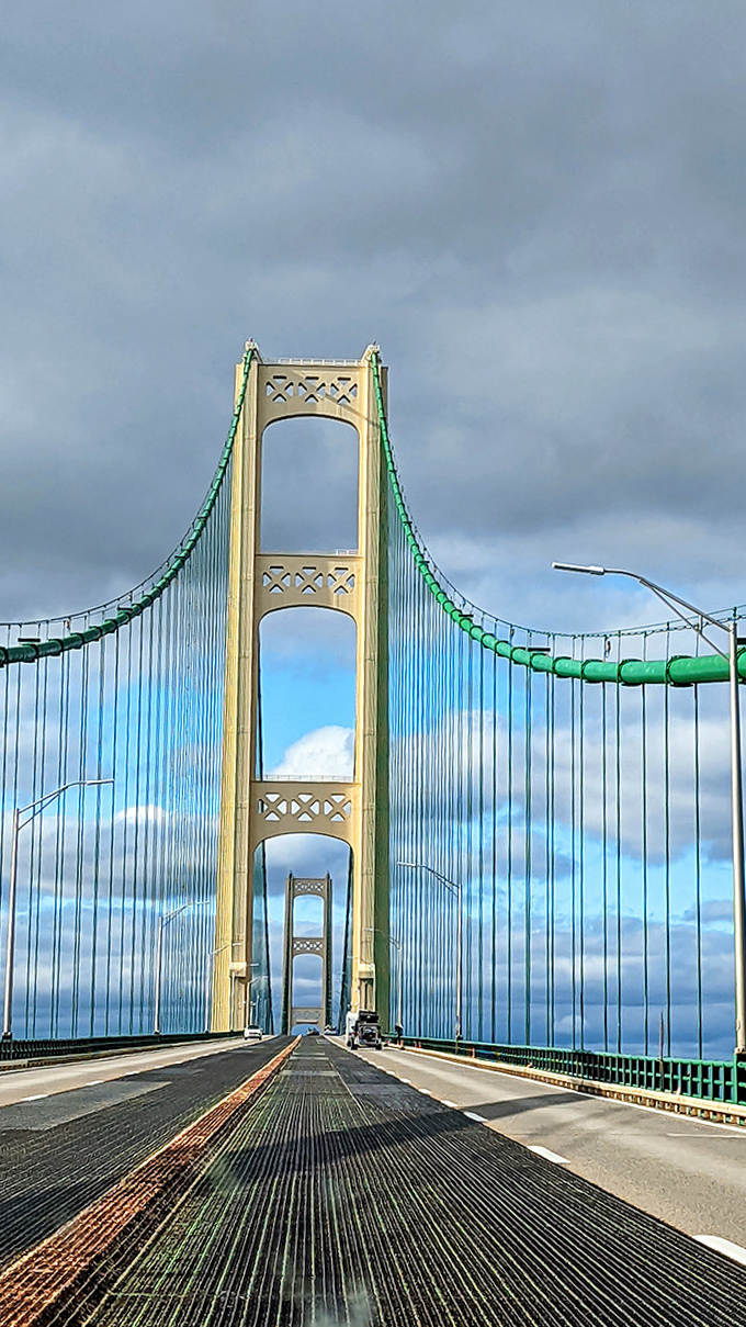 The Mackinac's suspended roadway creates the surreal sensation of floating above the water, with nothing but steel cables between you and the sky.