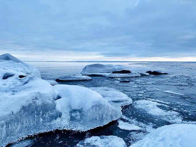 Winter transforms the shore into a crystalline wonderland, where ice sculptures replace summer's waves and frozen agates await discovery.