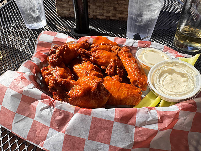 Buffalo wings glisten with spicy sauce, ready to provide that perfect balance of heat and flavor that keeps you reaching for more.