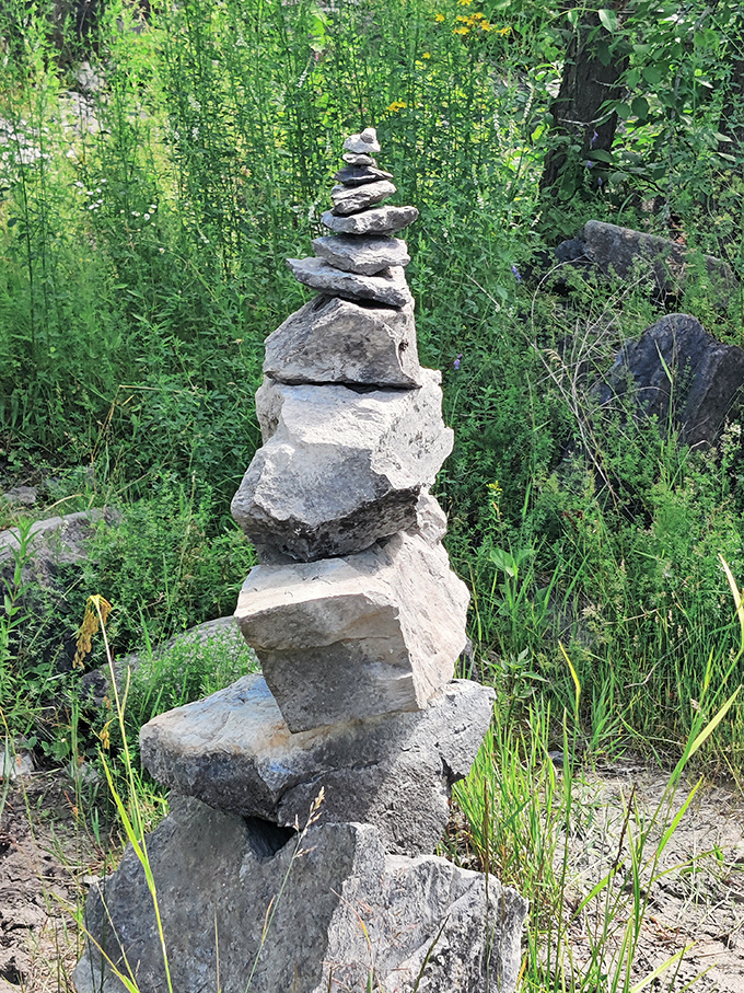 Stone cairns mark the way, modern monuments standing among much older geological treasures.