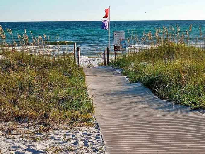 The dune crossover path winds through coastal vegetation, each step bringing you closer to that "ahhhh" beach moment.