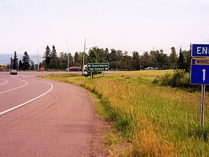 The eastern terminus of Highway 1 welcomes travelers with golden fields stretching toward the horizon, a prelude to adventures ahead.
