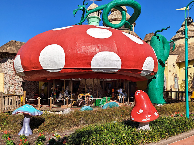 The Enchanted Carousel's giant mushroom canopy shelters riders as they spin through a wonderland of imagination and delight.