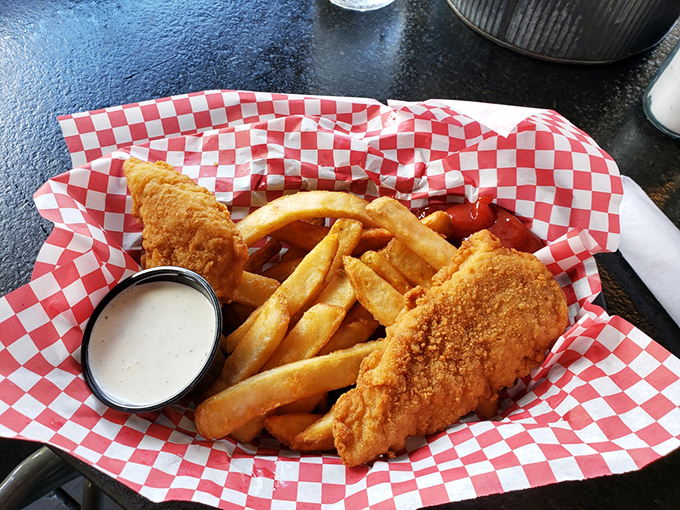 Golden-battered fish nestled alongside perfectly crisp fries&mdash;a classic combo elevated to art form with a side of creamy dipping sauce.
