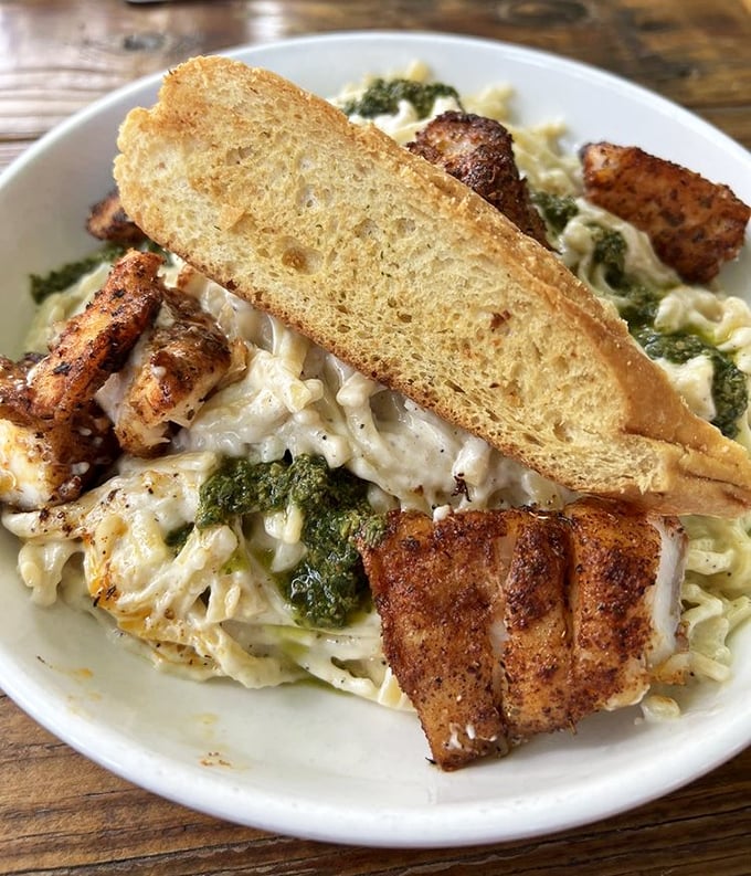 Blackened fish meets creamy pasta in this Alfredo that balances richness with the bright pop of basil pesto and perfectly cooked seafood.