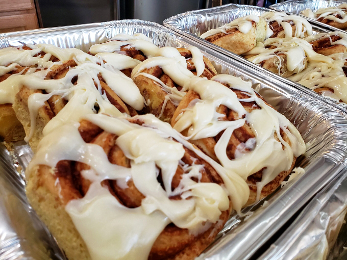 Cinnamon rolls drizzled with vanilla icing that's having an identity crisis as a waterfall &ndash; gloriously excessive and worth every calorie.