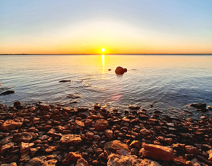 Joliet Park's serene waters reflect the sky, creating a double dose of blue tranquility that's more soothing than any retirement brochure could promise.
