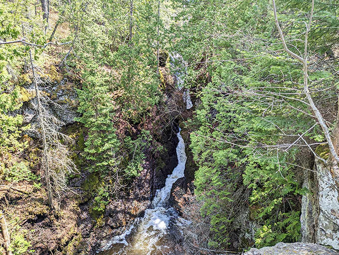 Manganese Falls cascades through a rocky gorge, offering a refreshing reward for hikers willing to venture slightly off the beaten path.