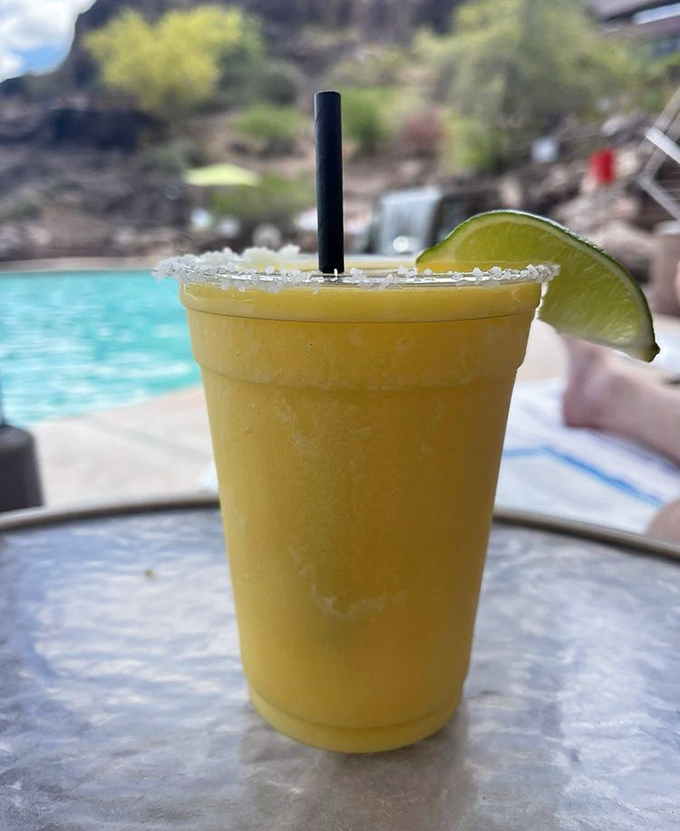 A frosty mango margarita stands guard by the pool, its salt rim glistening like Arizona's famous salt flats in the desert sun.
