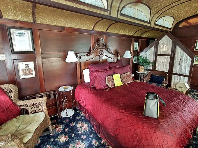 Sleep like royalty in this master suite, featuring ornate wooden headboards, rich linens, and classic floral-patterned carpeting throughout.