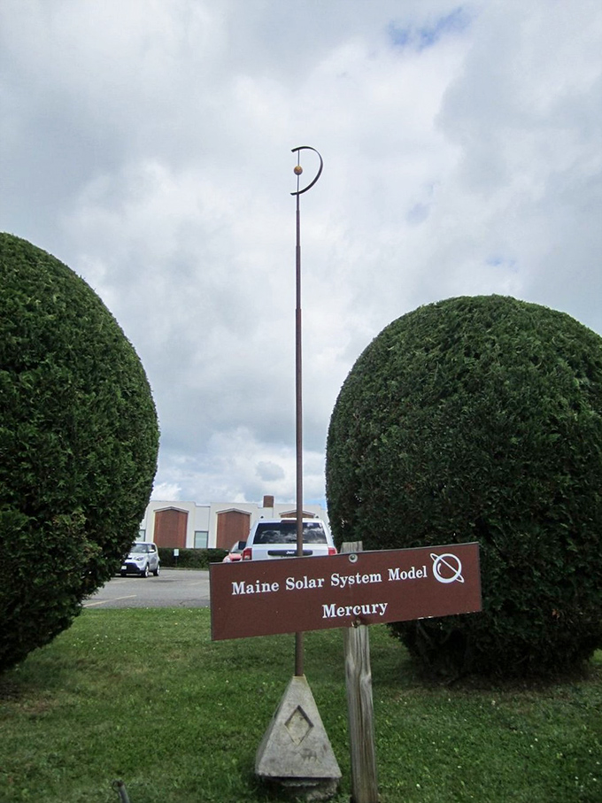 Mercury stands sentinel between perfectly manicured shrubs, the solar system's smallest planet making a big impression on Route 1.