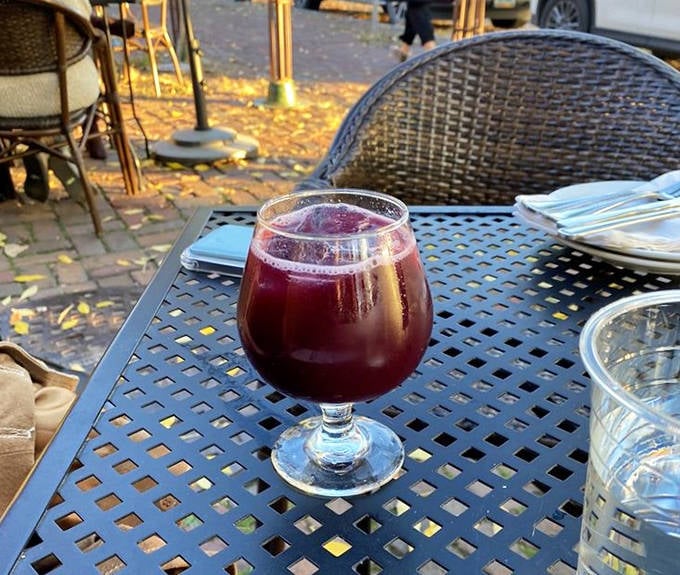 The Nitro Sangria glows like a ruby jewel in its glass, promising fruit-forward refreshment with a silky, nitrogen-infused texture.
