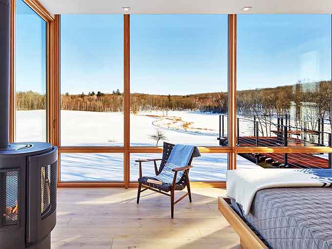 Floor-to-ceiling windows turn the bedroom into a treehouse for grown-ups, where waking up means opening your eyes to Wisconsin's greatest hits album of scenery.