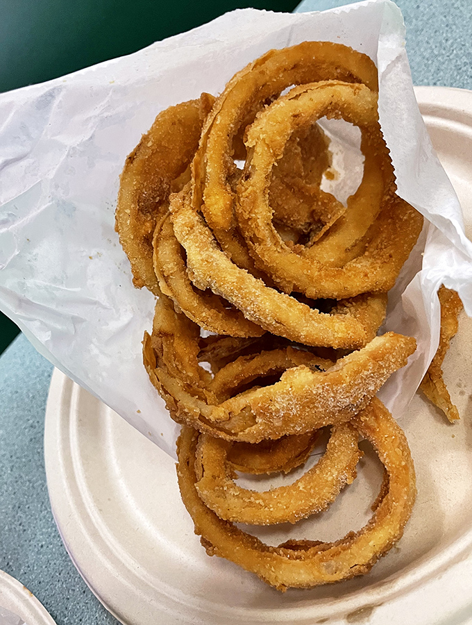 These golden onion rings aren't just a side dish – they're crispy circles of joy that deserve their own moment in the spotlight.