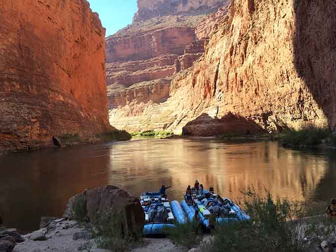 That's not just any blue boat, that's your ticket to one of the most spectacular natural wonders hiding at the canyon's bottom.