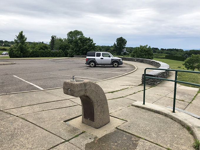 The curved parking area hugs the hillside, designed to minimize intrusion on the natural beauty that draws visitors.