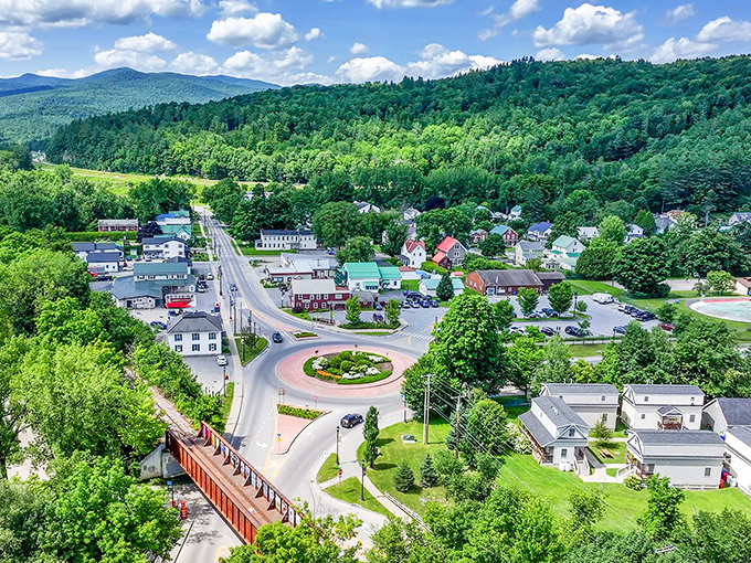 That roundabout isn't just traffic management, it's your invitation to explore in every direction, with mountains standing guard over your choices.