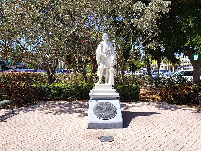 The St. Armands Circle monument stands as a testament to John Ringling's vision, surrounded by lush Florida landscaping that frames it perfectly.