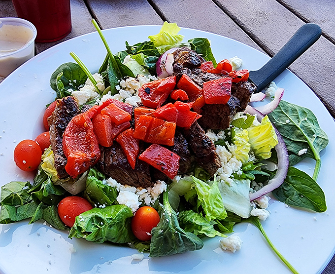 A steak salad that proves eating greens doesn't mean sacrificing flavor – those roasted red peppers are practically doing a happy dance with the beef. Photo credit: <a href="https://maps.google.com/maps/contrib/100360783475656933066" target="_blank" rel="noopener noreferrer">Y Hibbitts</a> A steak salad that proves eating greens doesn't mean sacrificing flavor – those roasted red peppers are practically doing a happy dance with the beef.