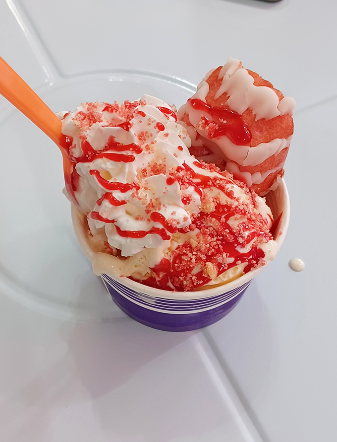 Strawberry shortcake reimagined &ndash; vanilla ice cream crowned with cake pieces and fresh strawberry topping creates a spoon-licking masterpiece.