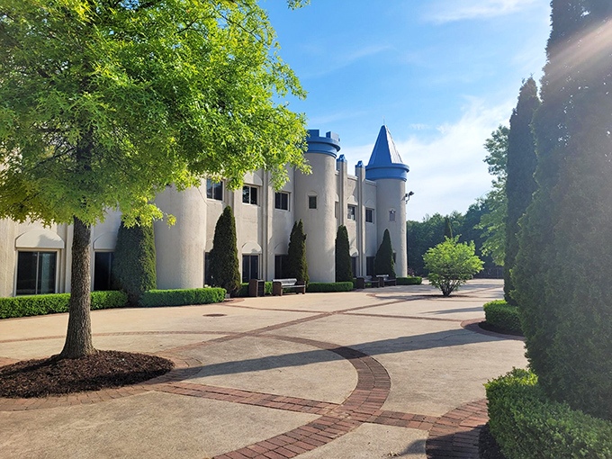 Morning light bathes the castle in golden warmth, highlighting every architectural detail while trees provide natural framing for this Michigan marvel.
