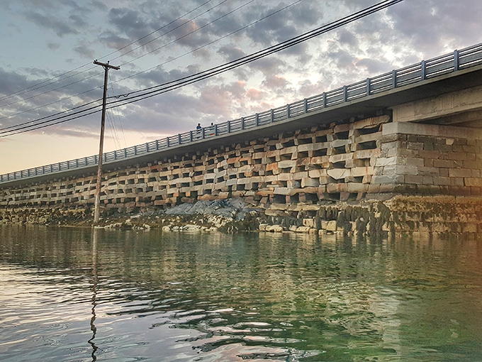 Twilight transforms the bridge into a silhouette against Maine's painted sky, a photographer's dream capture.