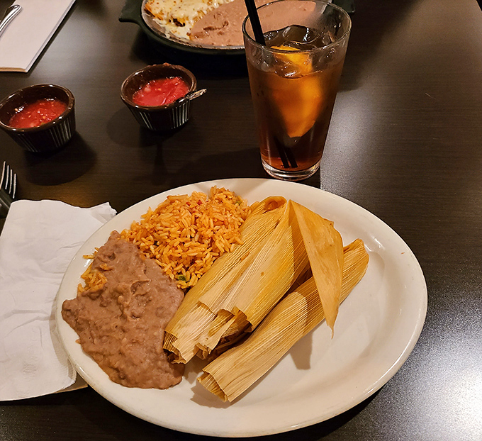Mexican tamales arrive wrapped in corn husks, hiding tender, savory fillings&mdash;simple, comforting, and rich with slow-cooked tradition in every bite.