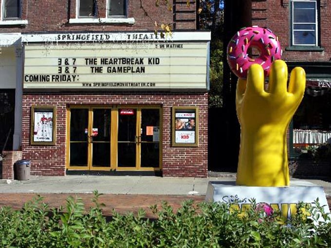 The Springfield Theater's classic marquee and that cheerful donut sculpture, because every town needs whimsy with history.